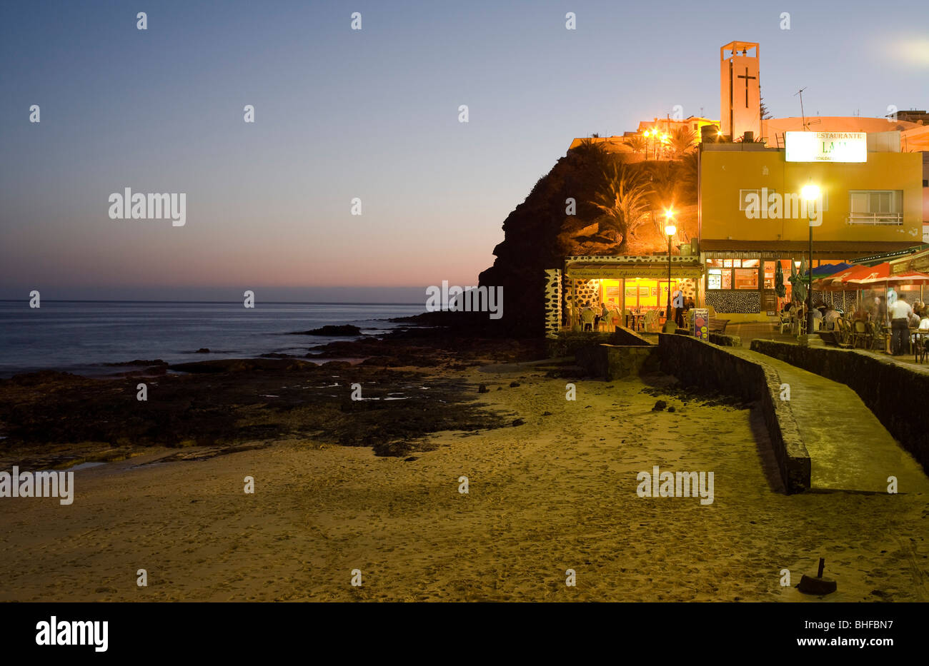 Illuminated restaurant at the beach at dusk, Morro Jable, Jandia ...