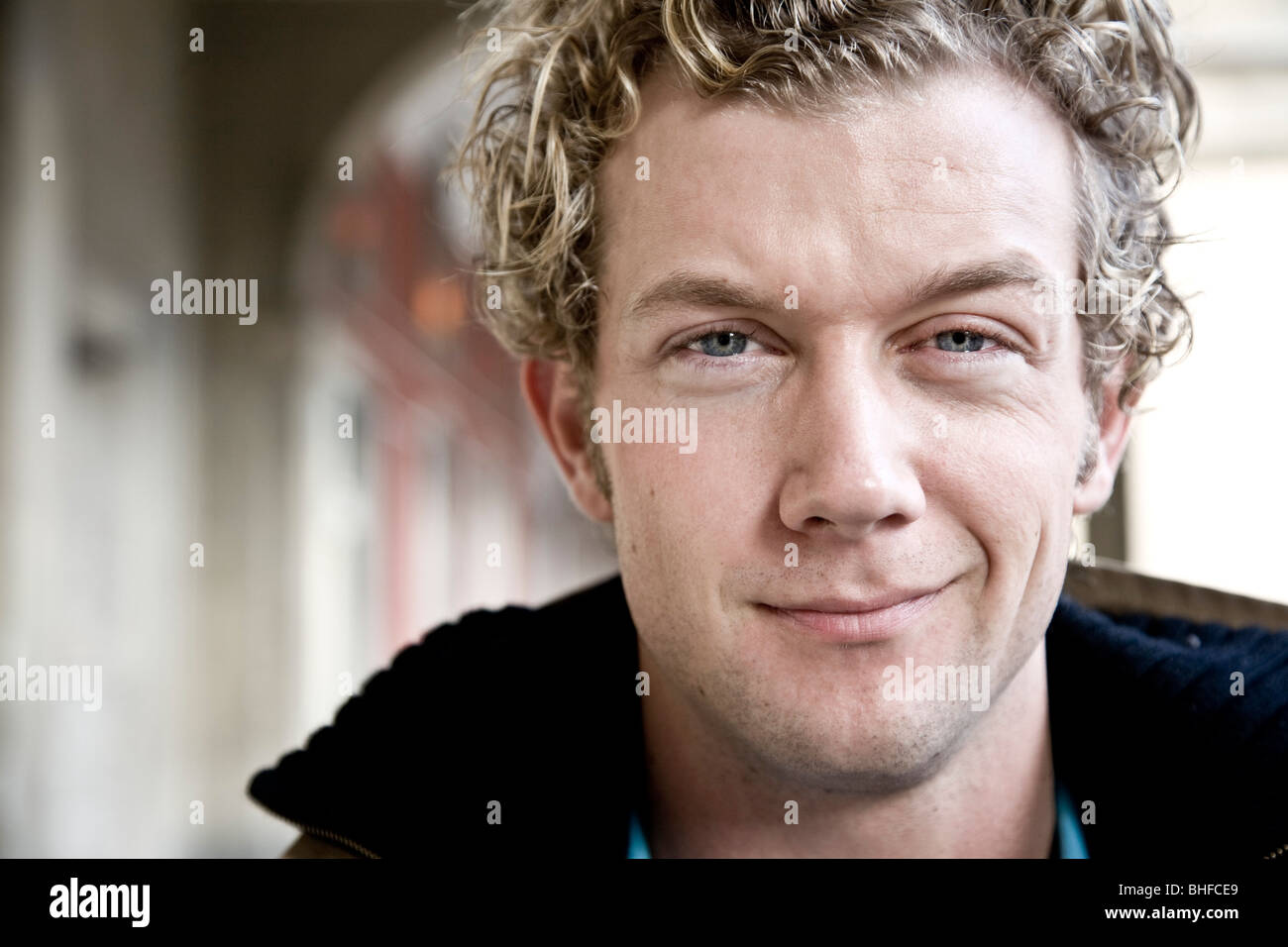 Young man grinning at camera, Munich, Bavaria, Germany Stock Photo - Alamy