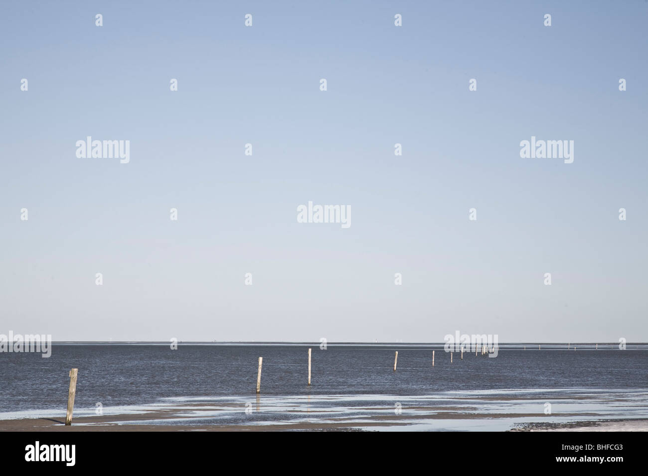Wodden piles at low tide, St Peter Ording, Wadden Sea National Park ...