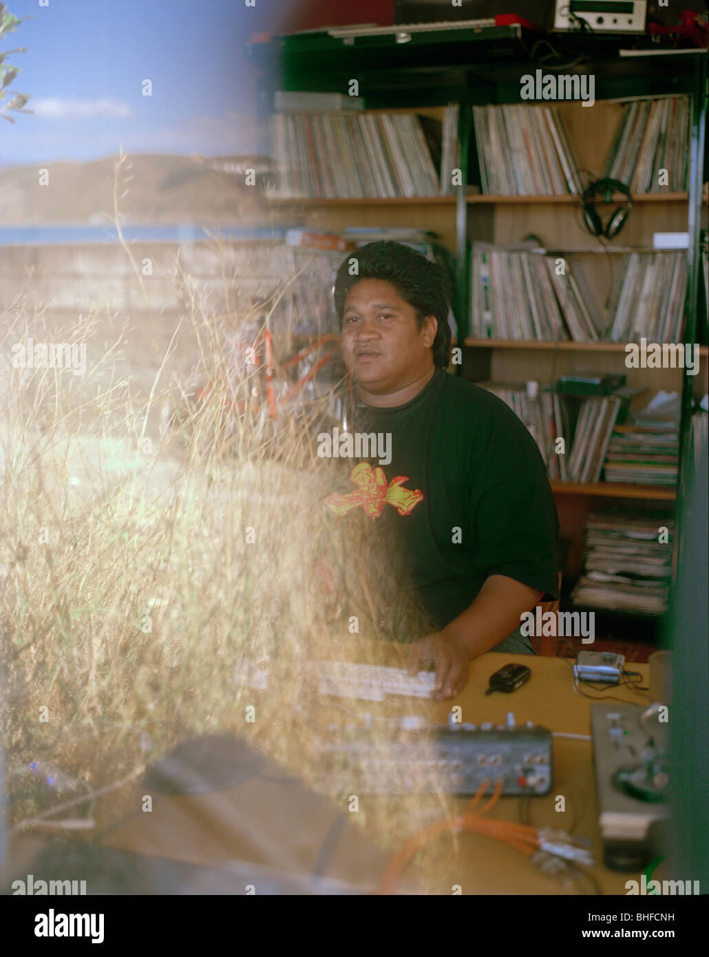 View through window at young man at a recording studio, Lyall Bay ...