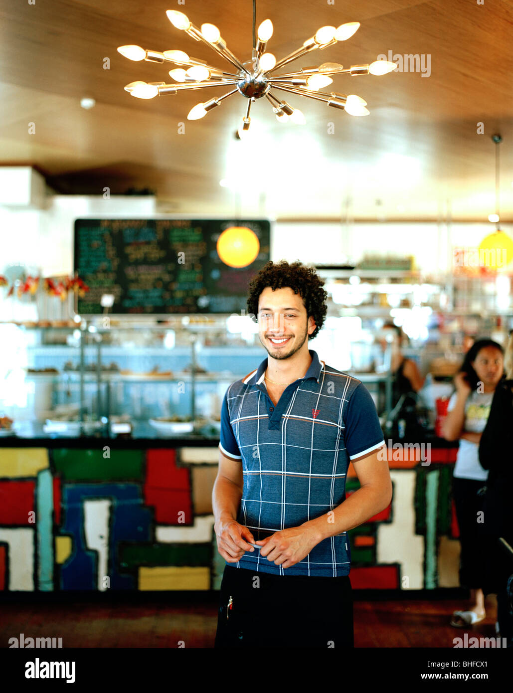 Smiling waiter at Maranui Café, The Maranui Surf & Lifesaving Café ...