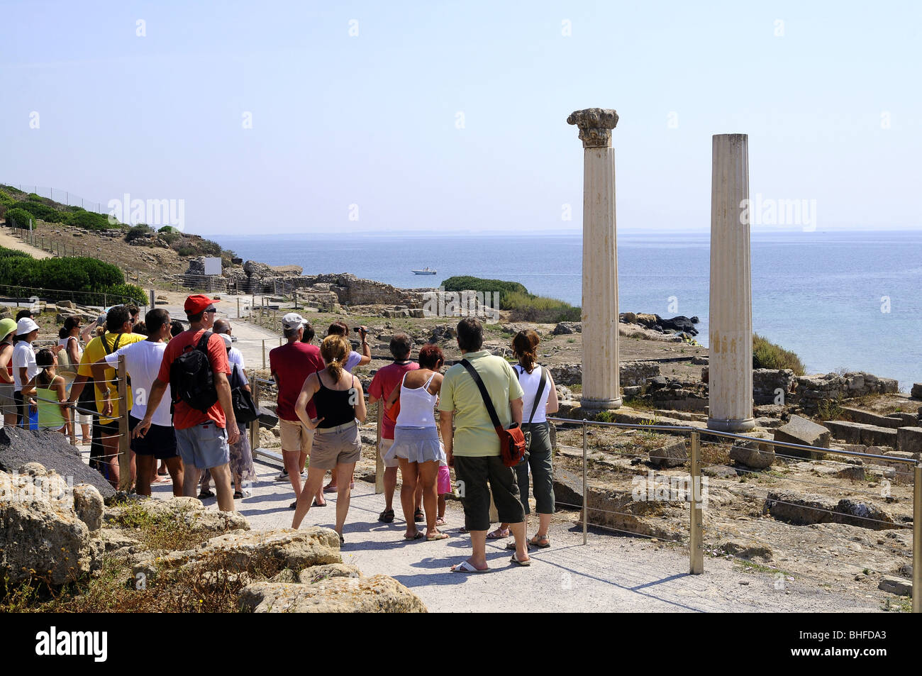 Tourists in front of roman excavation in the sunlight, antique town ...