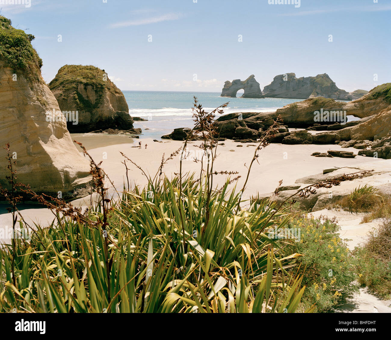 Sandy beach and rocky islands at Wharariki Beach, northwest coast ...