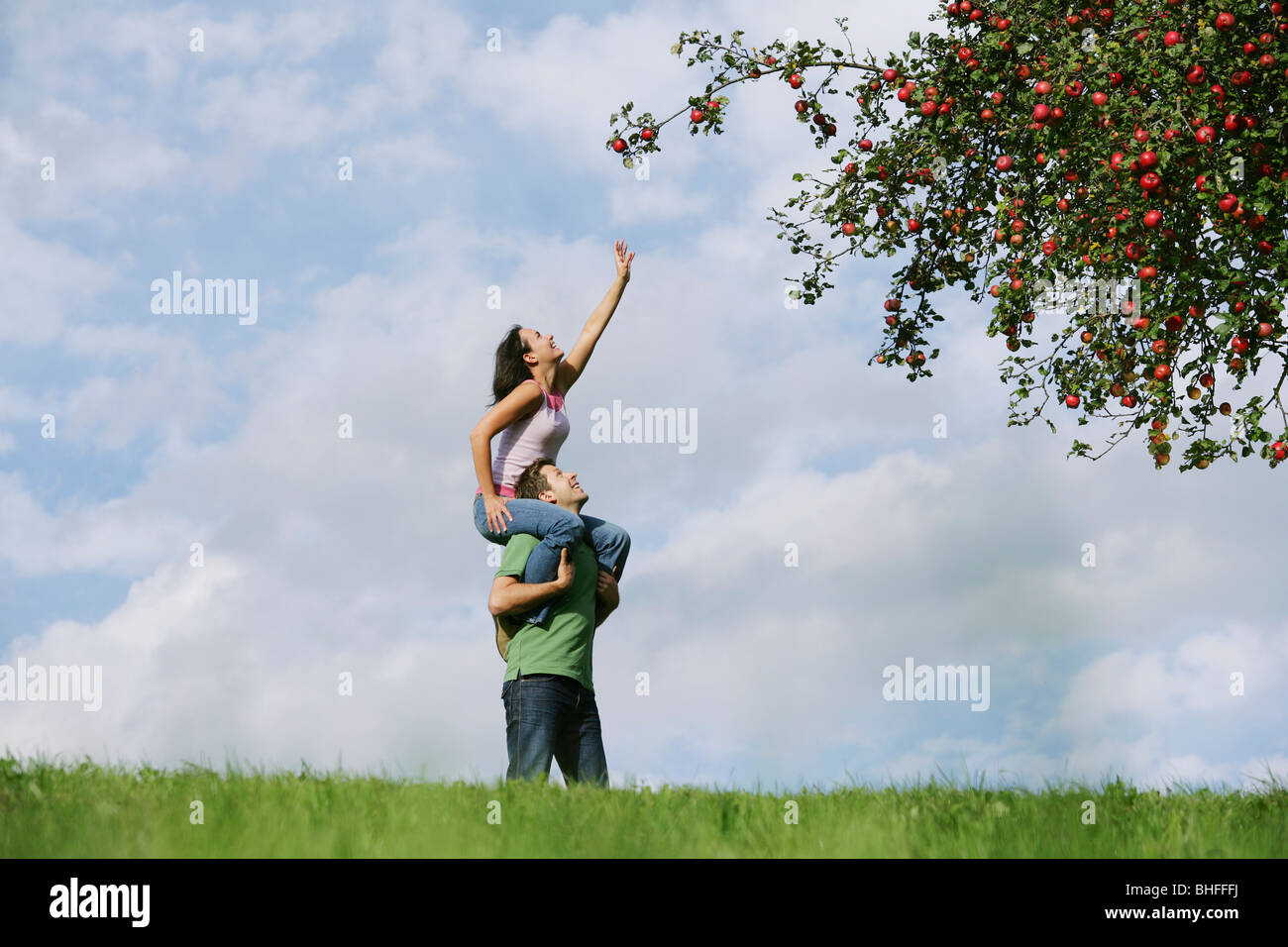 People reaching fruit on tree hi-res stock photography and images - Alamy