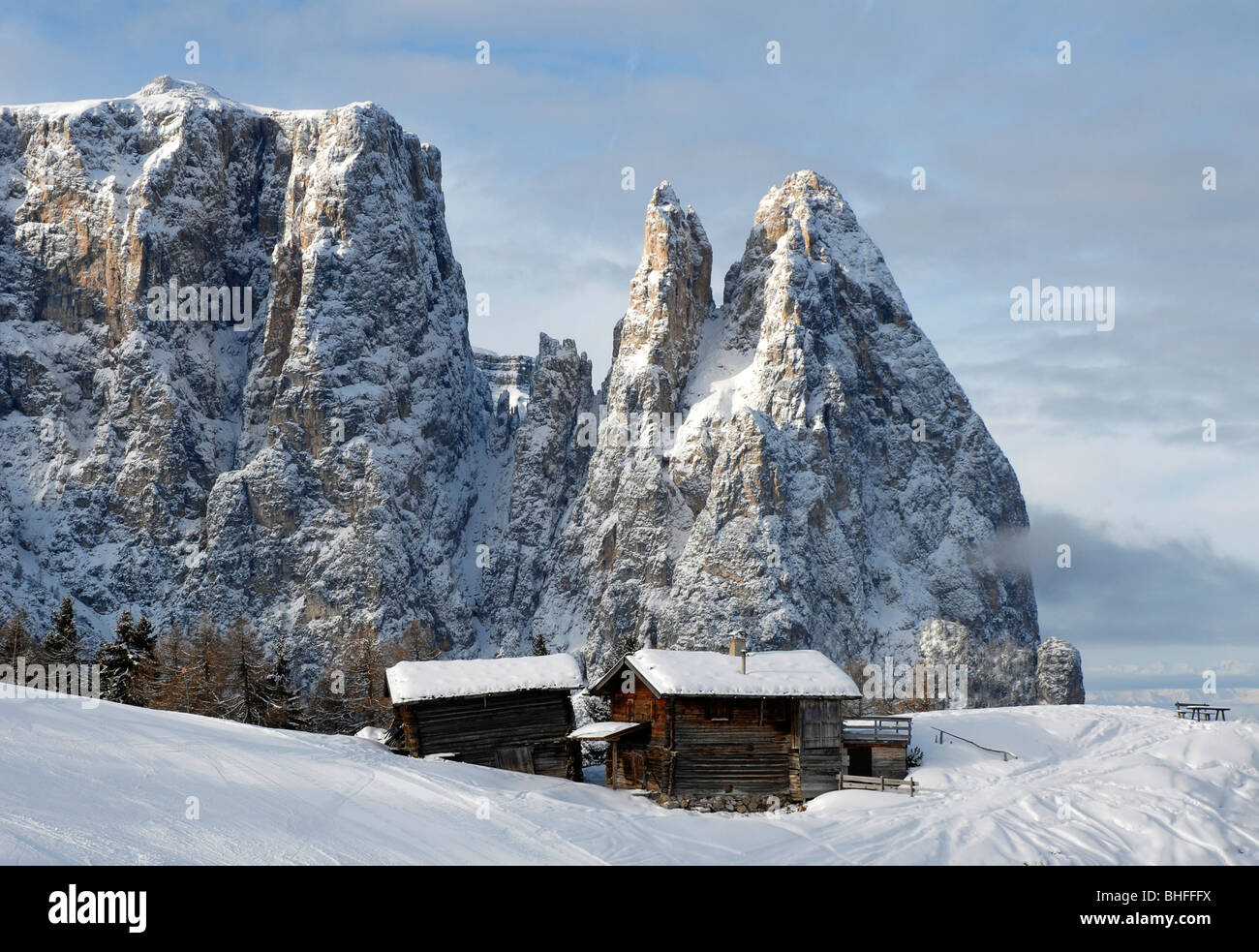 Alpine huts in front of snow covered mountains, Alpe di Siusi, South ...