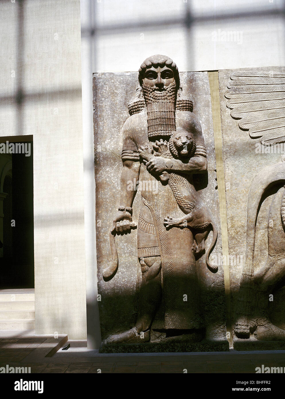 Assyrian sculpture of a man holding a lion, Khorsabad, c8th century BC ...