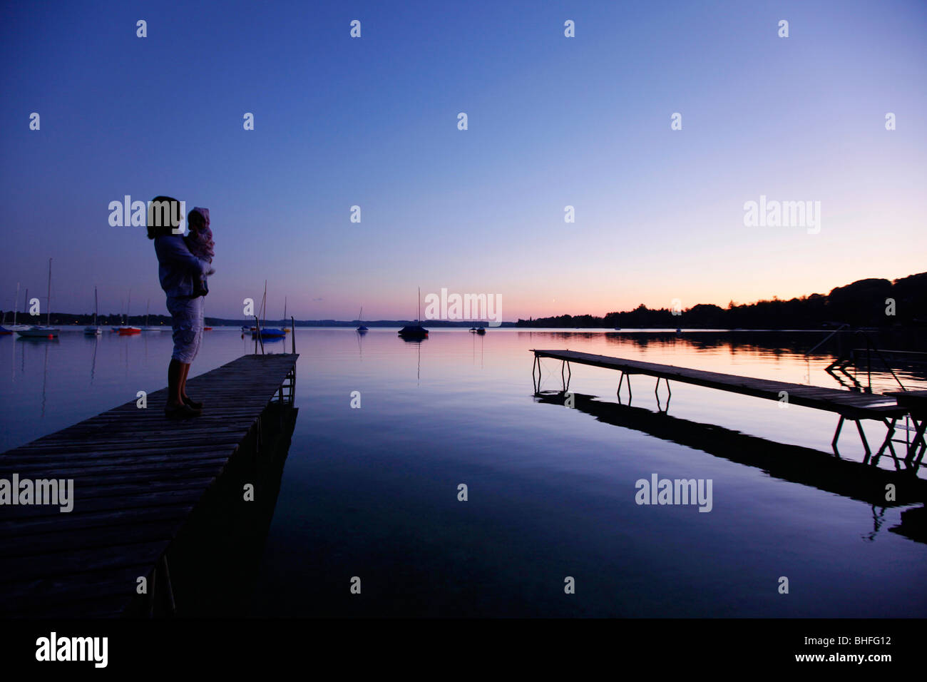 Jetty at lake Worthsee in dusk, Bavaria, Germany Stock Photo - Alamy