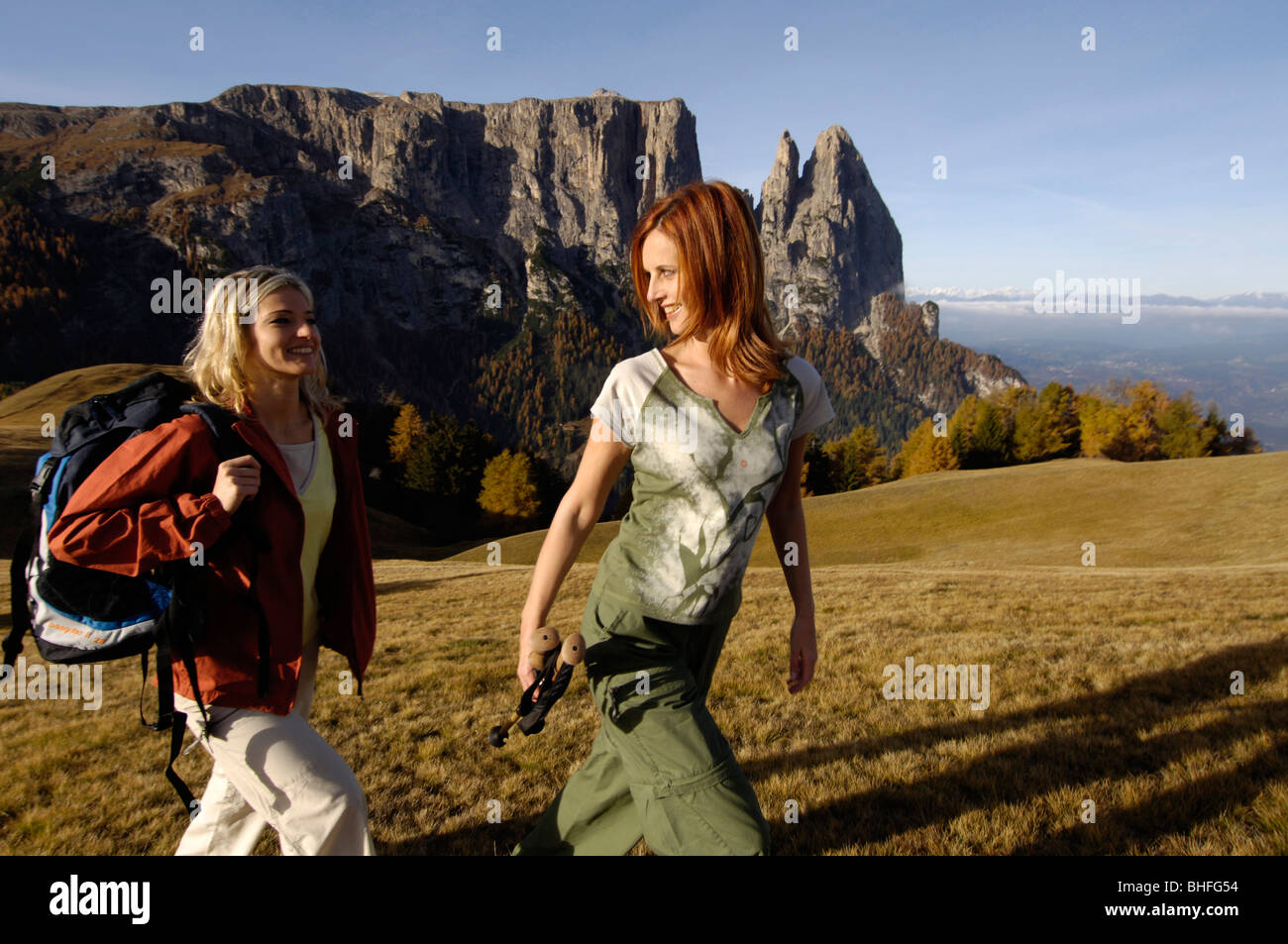 Two women hiking on an alpine meadow, Alpe di Siusi, South Tyrol, Italy ...