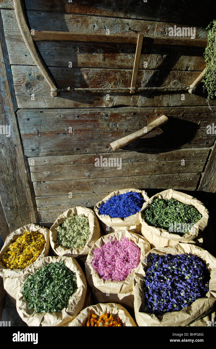Sacks of medicinal herbs in front of an alpine hut in the sunlight ...