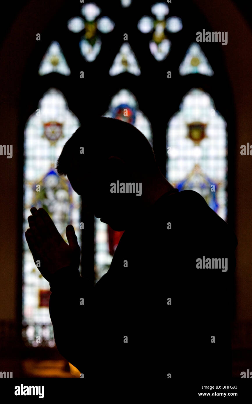 Man praying in a church Stock Photo - Alamy