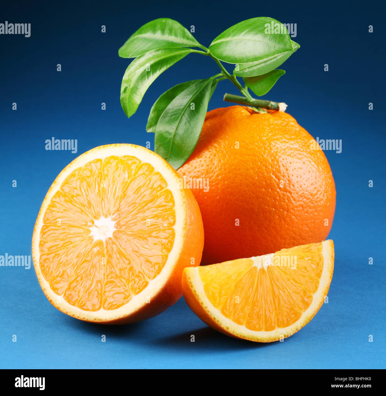 Ripe orange on a blue background Stock Photo - Alamy