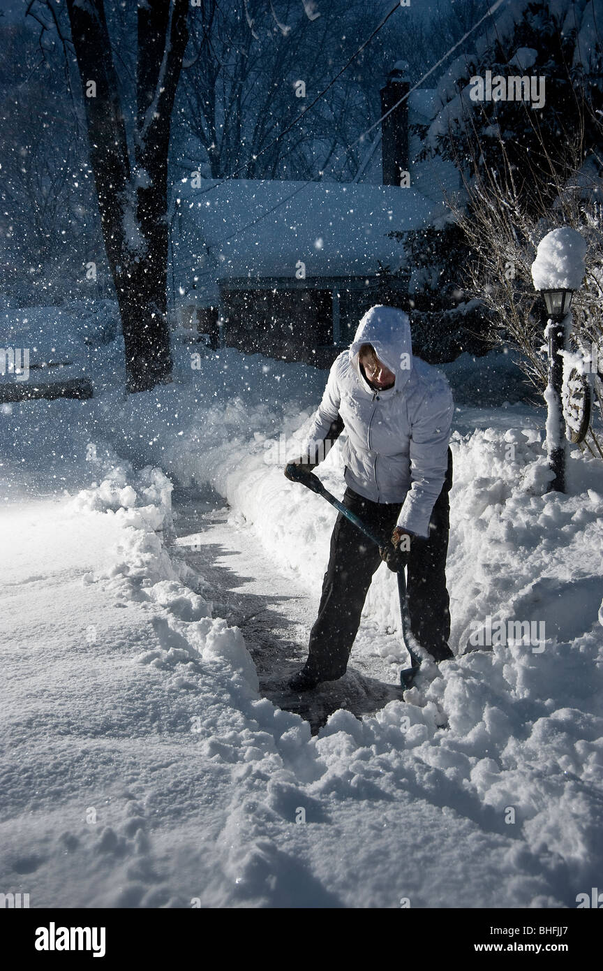 Man shoveling snow at night hi-res stock photography and images - Alamy