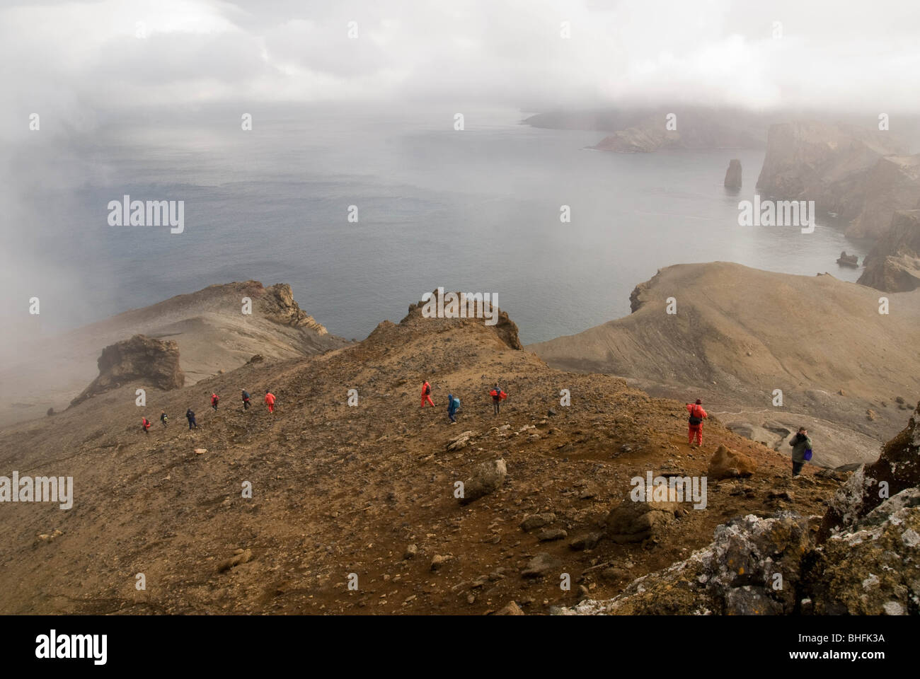 Tourists hike up the active volcano that forms Deception Island, in the ...
