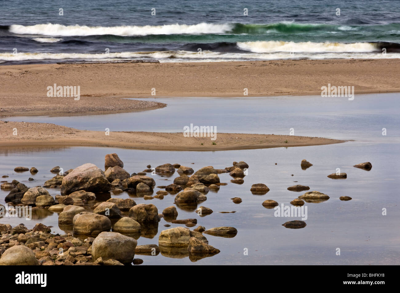 Sand bars and boulders at mouth of the Sand River with Lake Superior ...