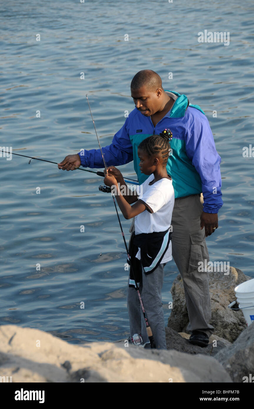 Father teaching daughter to fish Stock Photo - Alamy
