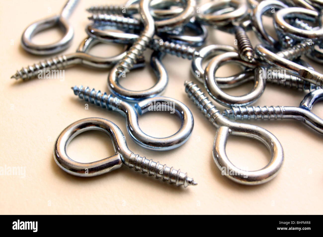 Chrome coloured Screw in eyelets Stock Photo - Alamy
