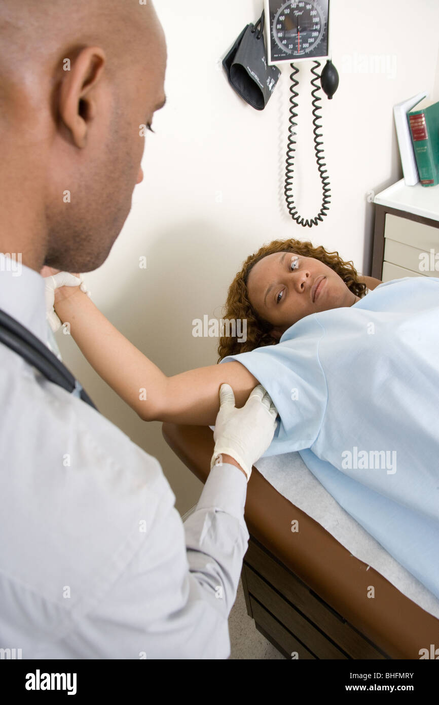 Female patient in hospital being cared for by nurse Stock Photo - Alamy