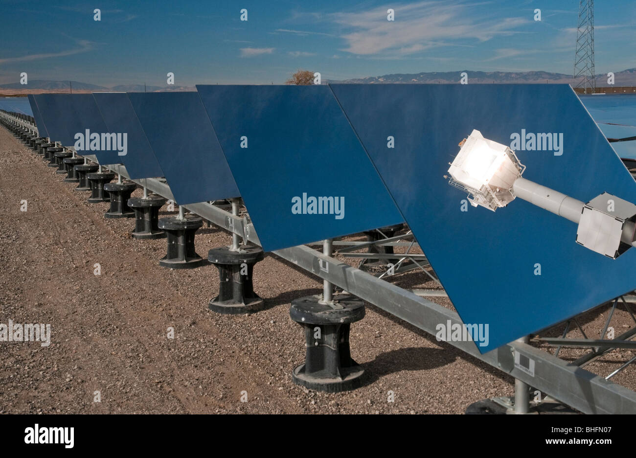 Heliostat mirrors with reflection of a tower-mounted receiver at a ...