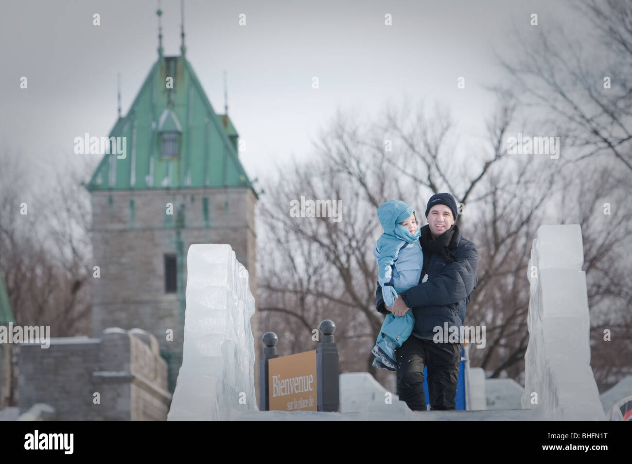 A man and his daughter prepare to ride an ice slide at the Quebec ...
