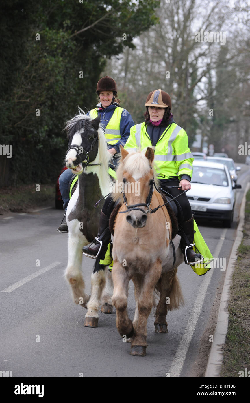 Horse riders on road with high visibility jackets Stock Photo - Alamy