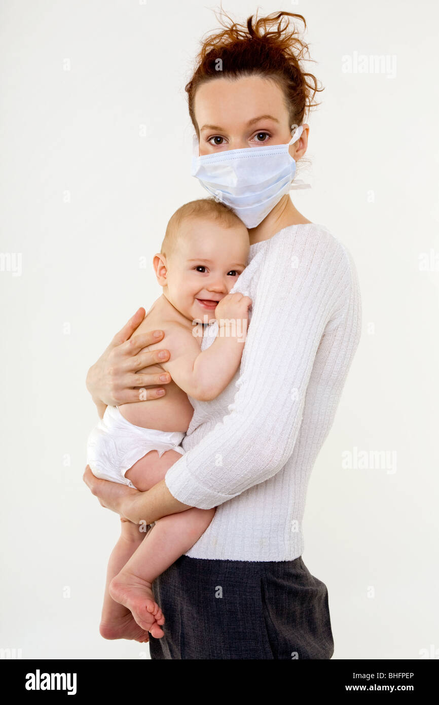 young mother in a protective mask with her adorable baby boy Stock ...
