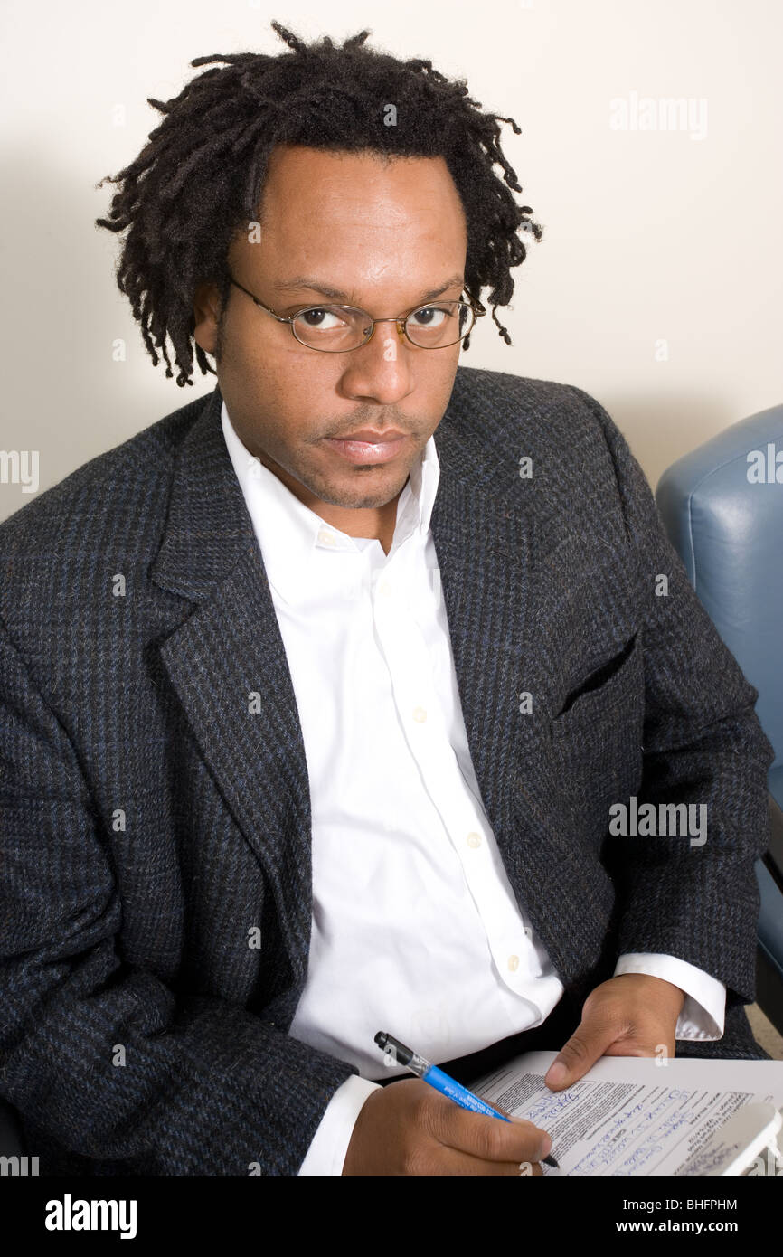 Young man answering questions in patient history form or seeking a job ...