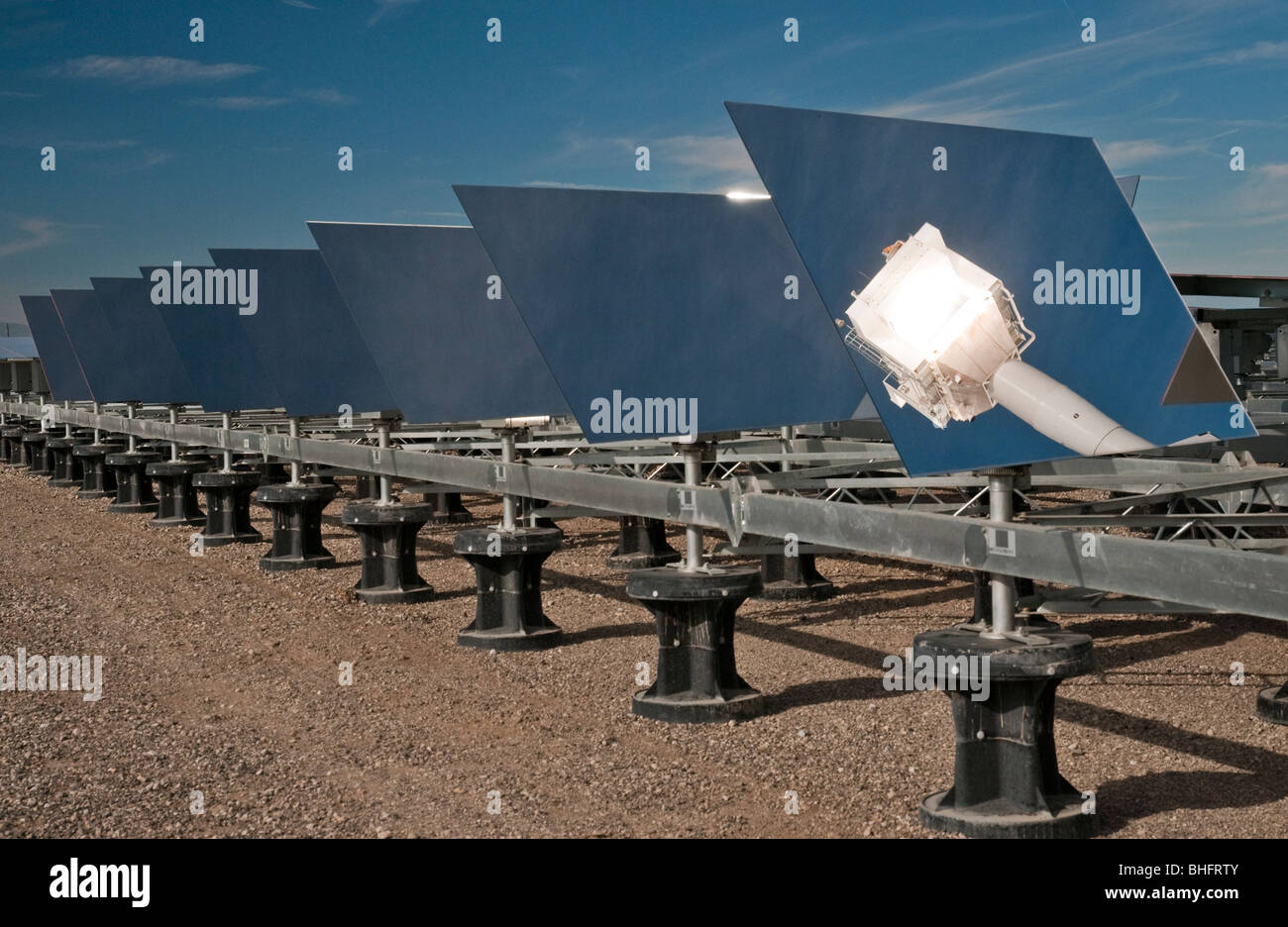 Heliostat mirrors with reflection of a tower-mounted receiver at a ...