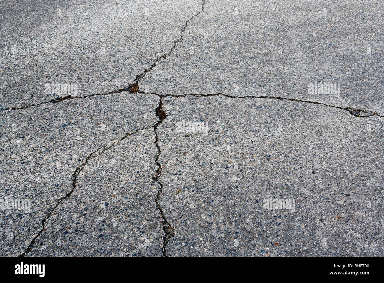 A cracked concrete street Stock Photo - Alamy