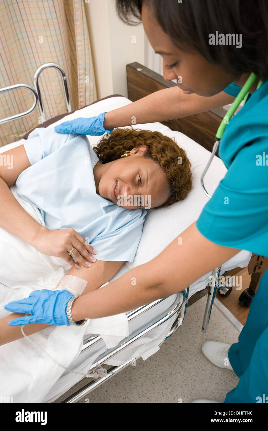 Female patient in hospital being cared for by nurse Stock Photo - Alamy