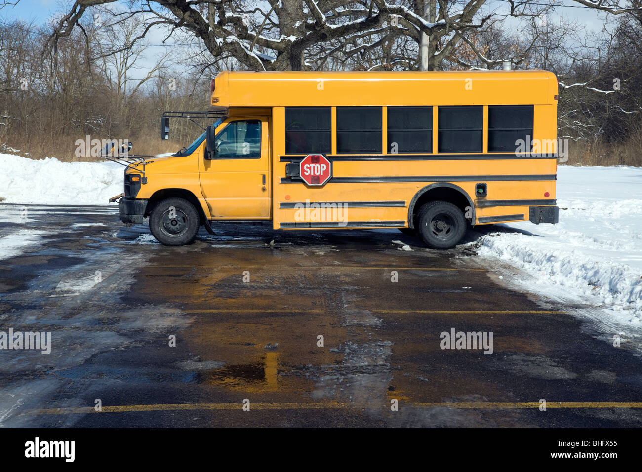 Small school bus on the parking lot - winter time Stock Photo - Alamy