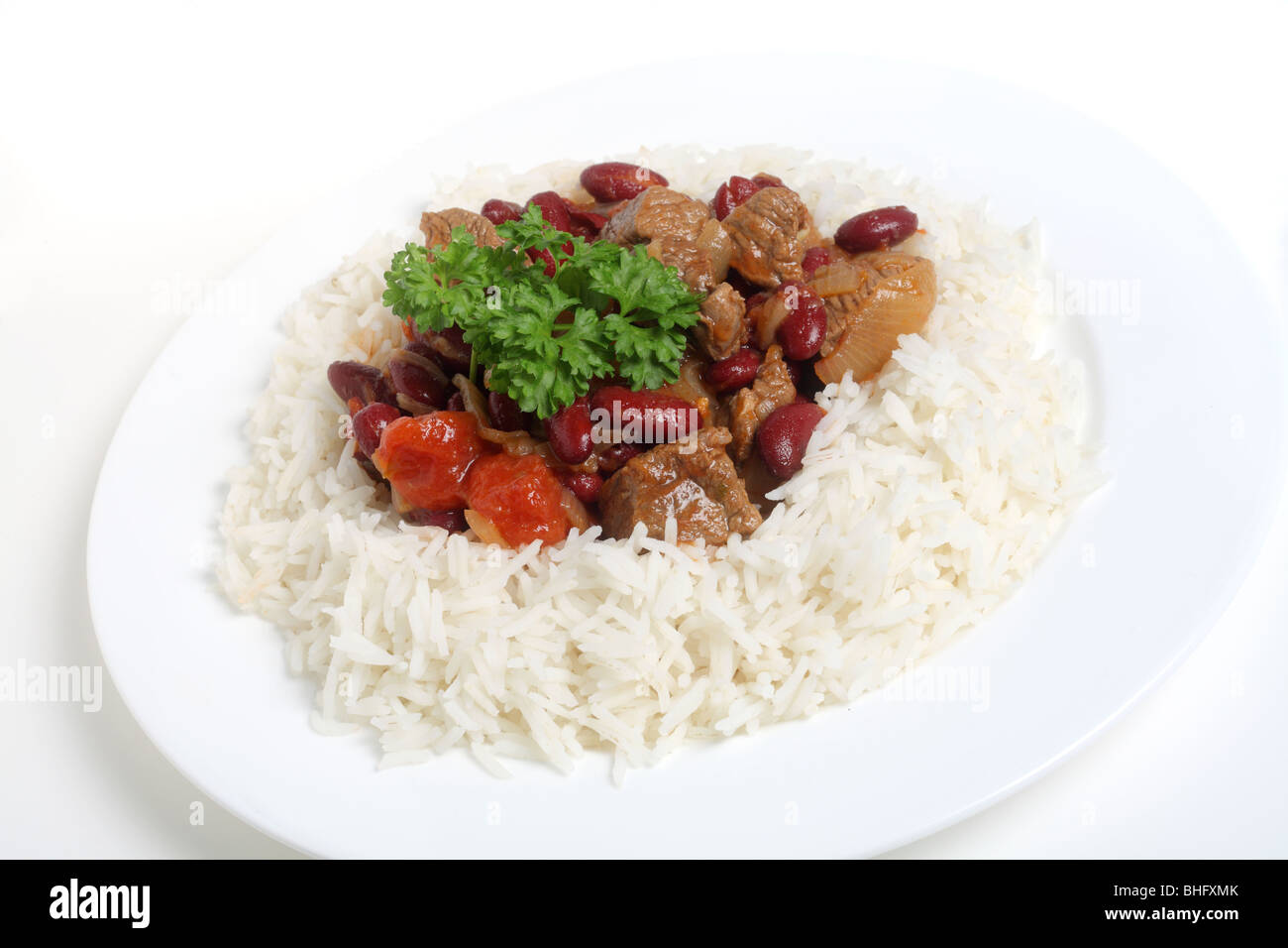 A plate of chilli con carne with rice over a white background Stock ...