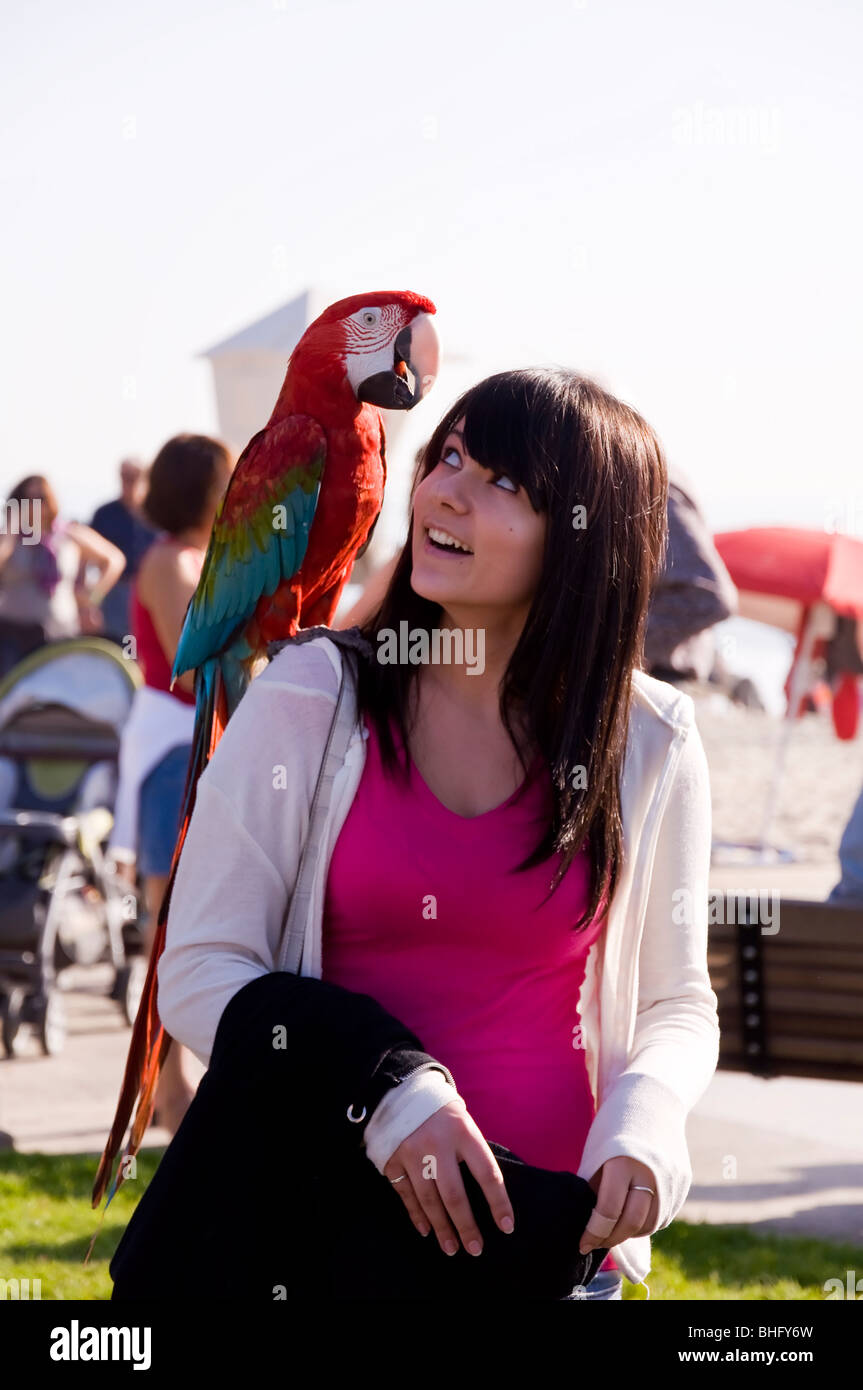 Teenager girl with parrot Stock Photo - Alamy