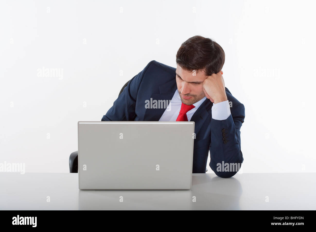 Worried businessman sitting behind hi-res stock photography and images ...