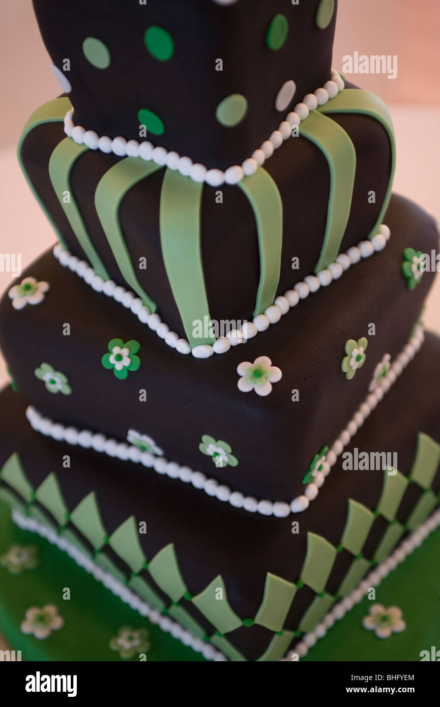 Fanciful wedding cake with tilting tiers and green and chocolate ...