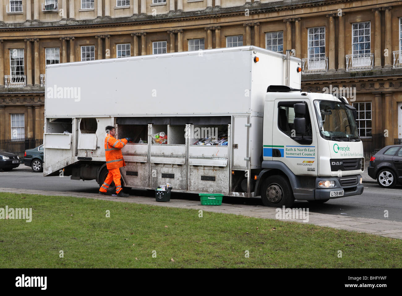 A May Gurney recycling truck and operative stands before Georgian town ...