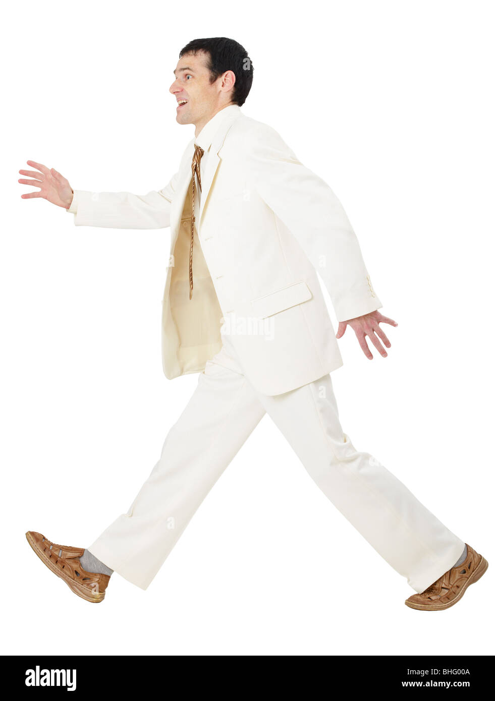 Happy businessman in a white suit somewhere in a hurry Stock Photo - Alamy