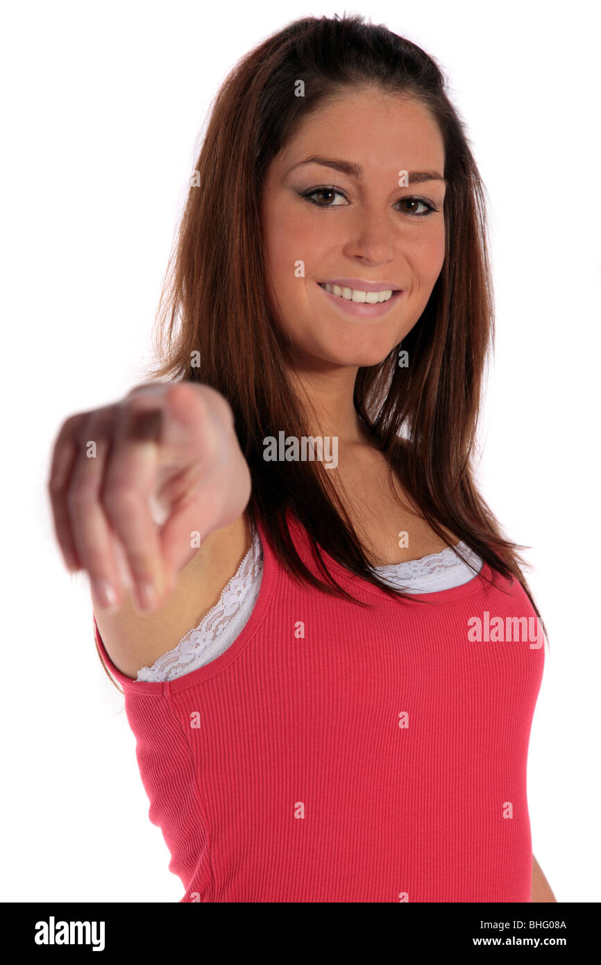 An attractive young woman pointing at someone. All isolated on white ...