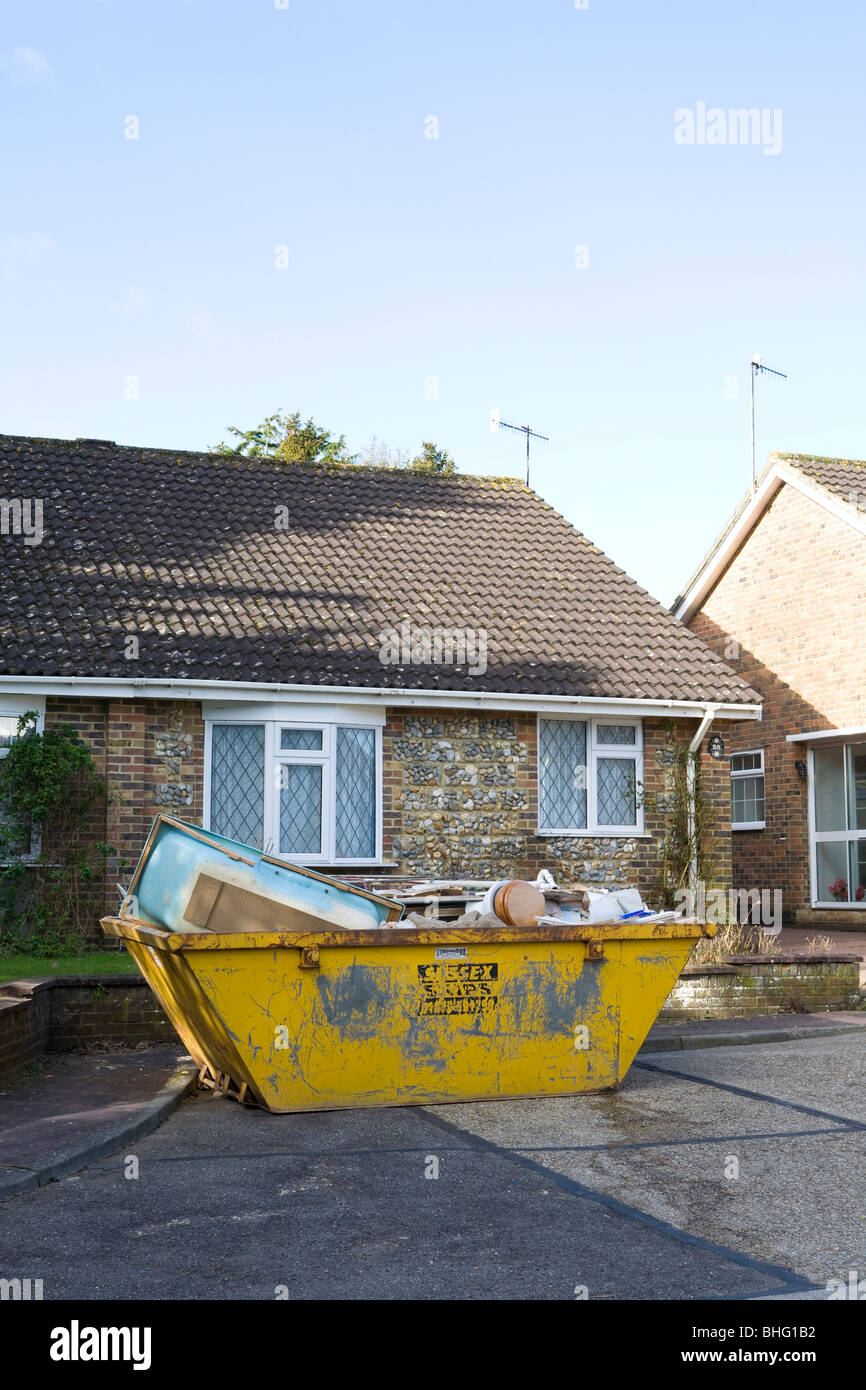 Skip outside Sussex house during renovations Stock Photo - Alamy
