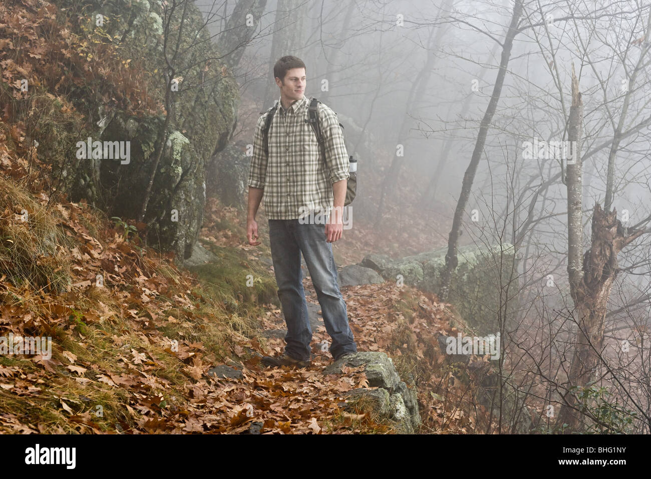 A male hiker explores a misty forest Stock Photo - Alamy