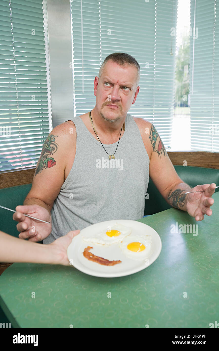 Waiter serving an angry man Stock Photo - Alamy