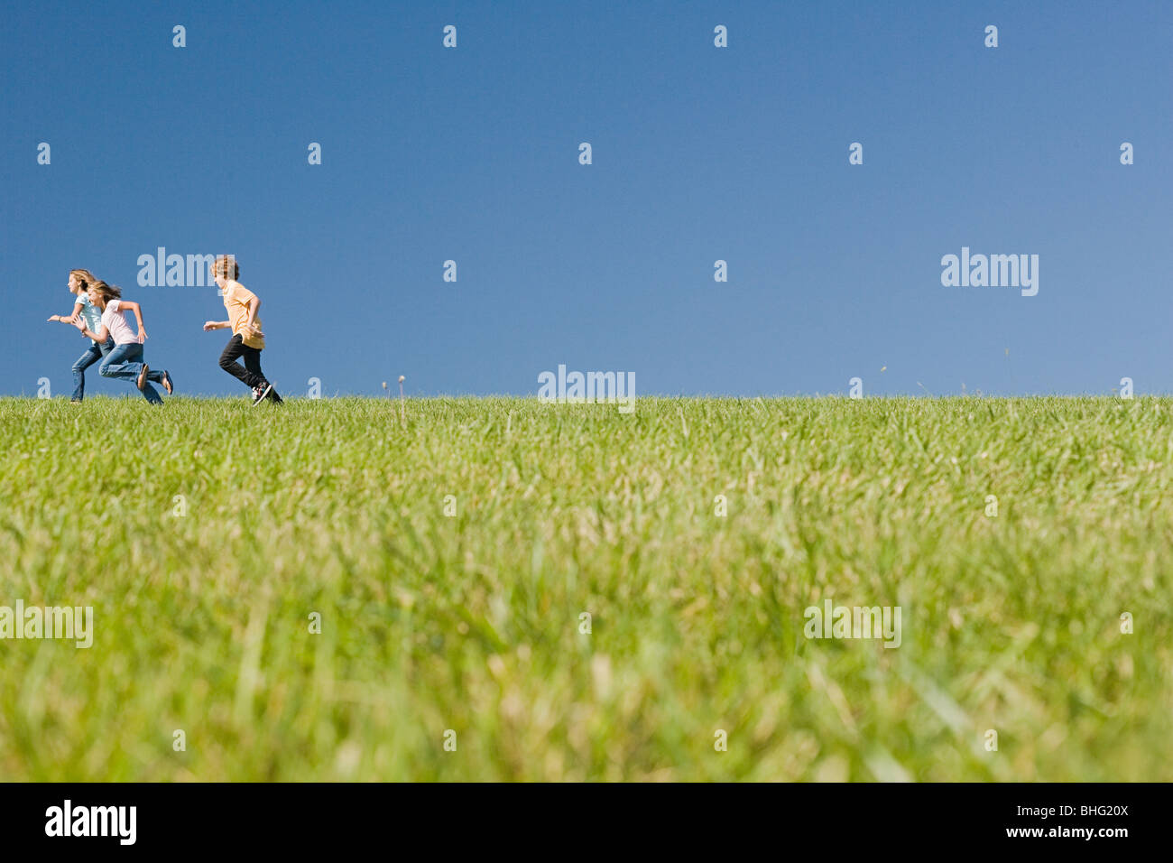 Children running in field Stock Photo - Alamy