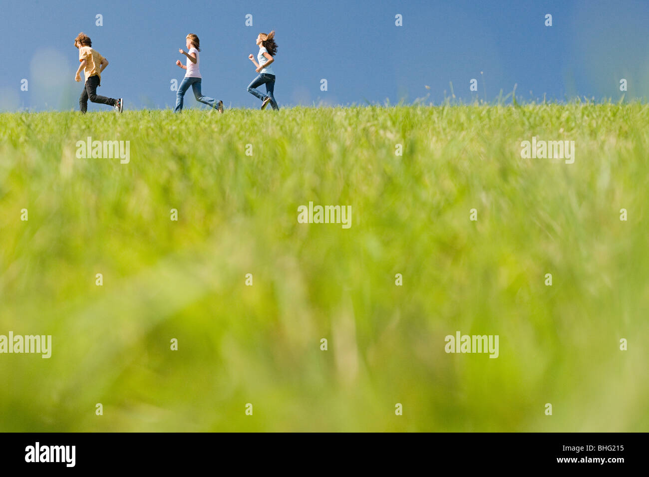 Children running in field Stock Photo - Alamy