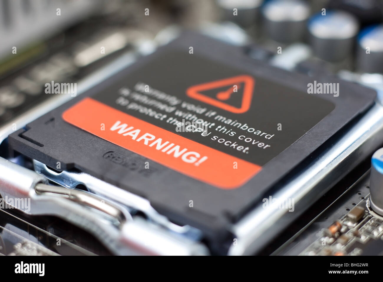 "WARNING" phrase on the protective socket of CPU cover Stock Photo - Alamy