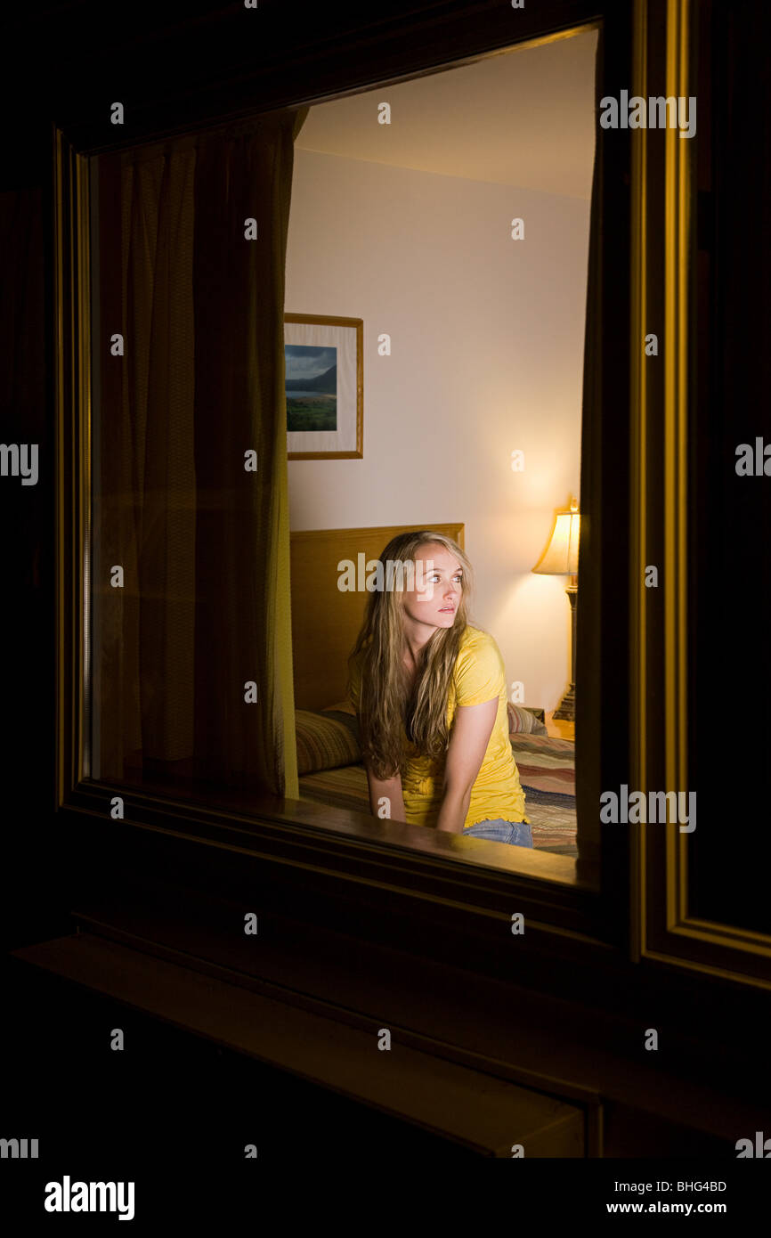 Young woman in motel room Stock Photo - Alamy