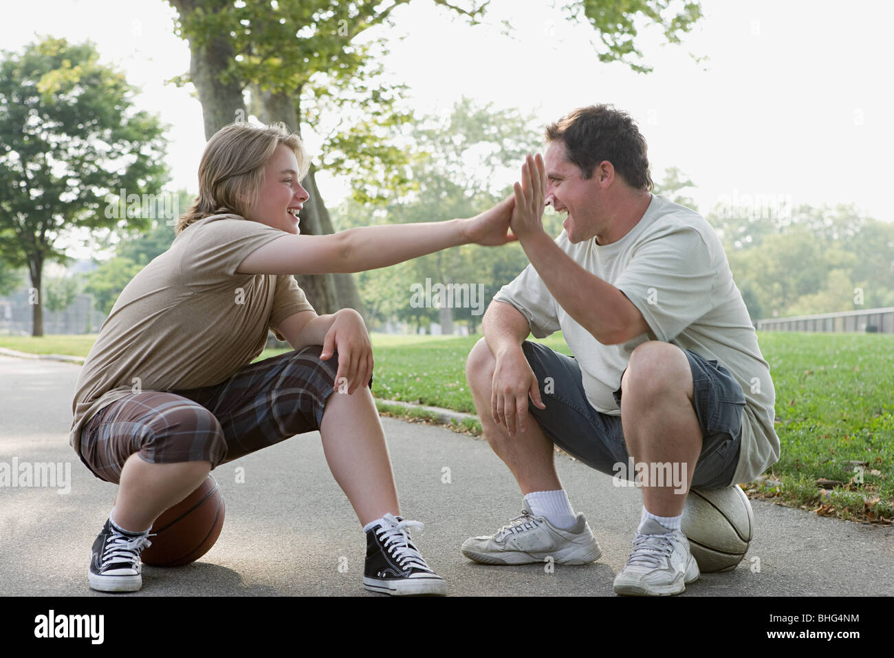Father and son doing high five Stock Photo - Alamy