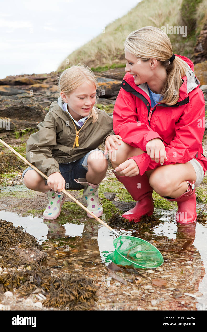 Young people looking at rock pools hi-res stock photography and images ...
