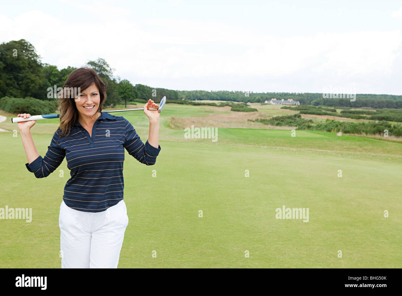 Woman on golf course Stock Photo - Alamy