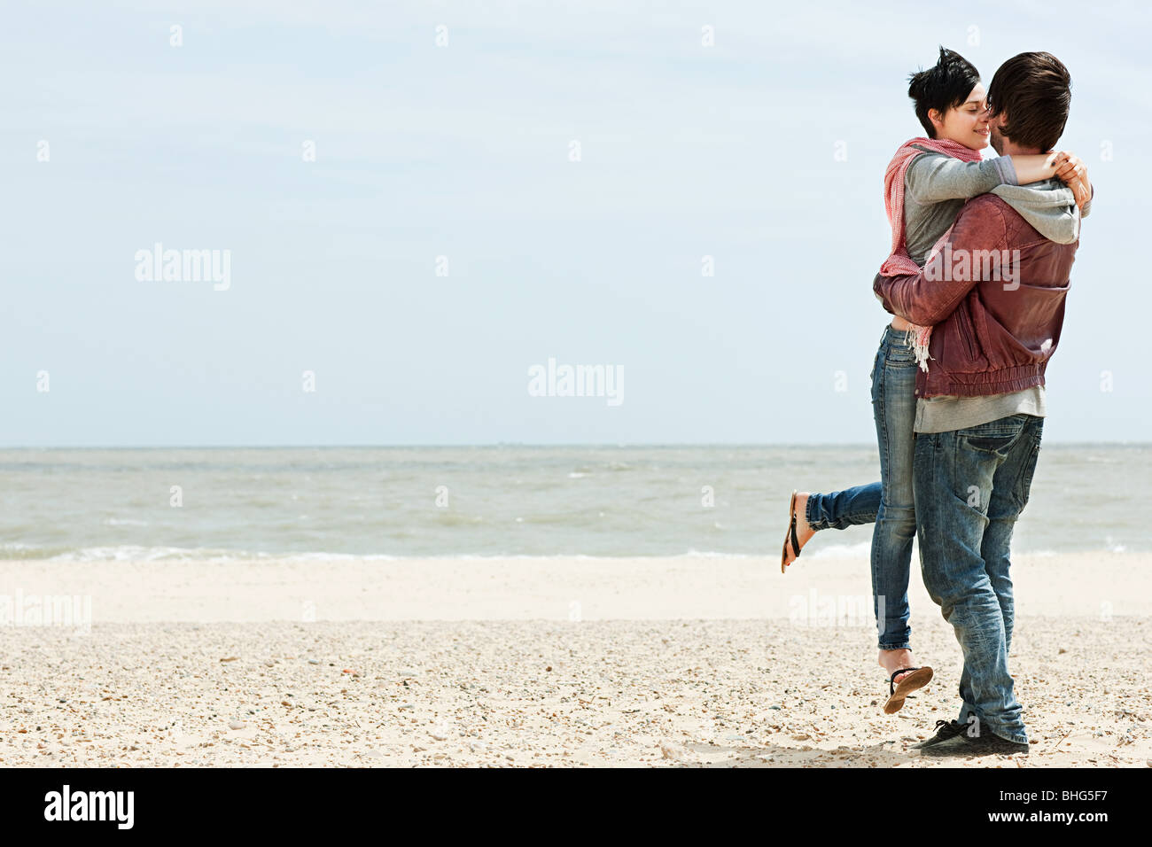 Young couple by the sea Stock Photo - Alamy