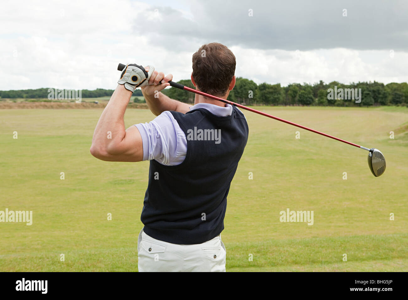 Rear view of a male golfer Stock Photo - Alamy