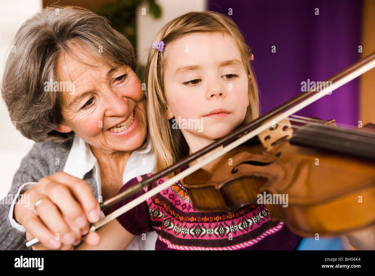 Grandparent teaching music child hi-res stock photography and images ...
